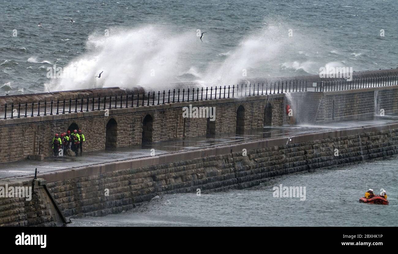 Rescue teams make their way back along Tynemouth pier wall after ...