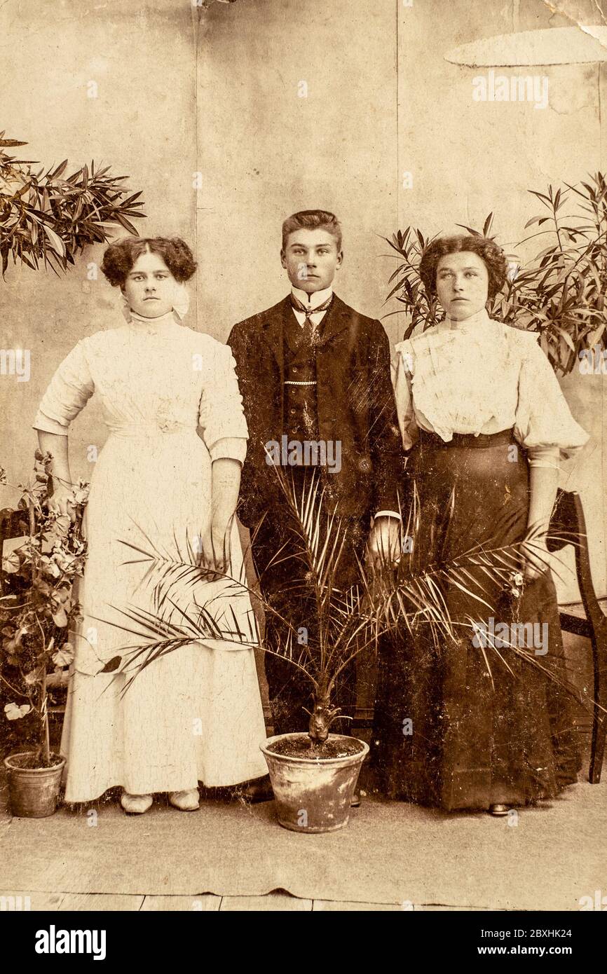 Germany - CIRCA 1900s: Group portrait shot of two female and man in ...
