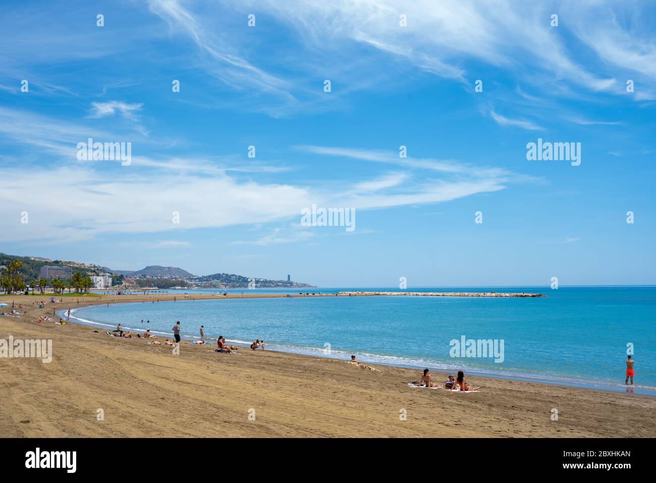 Calm beach with people enjoying a summer day. Bay landscape with a ...