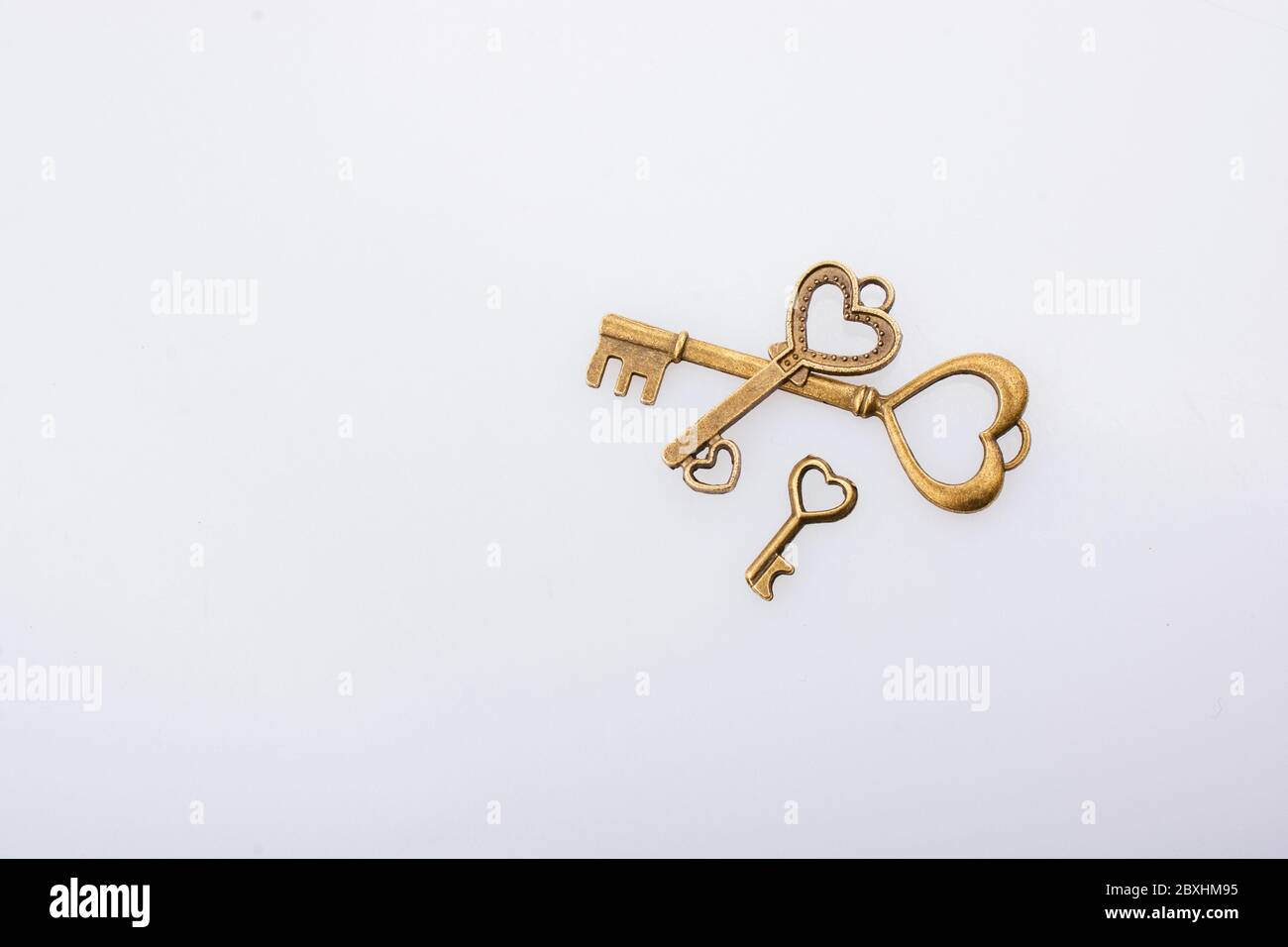 Heart shaped retro metal keys on white background Stock Photo - Alamy