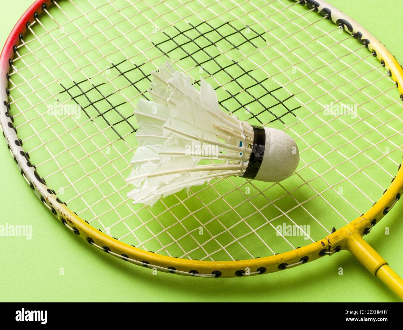 Badminton racket and White Feather Shuttlecock with a colour green ...
