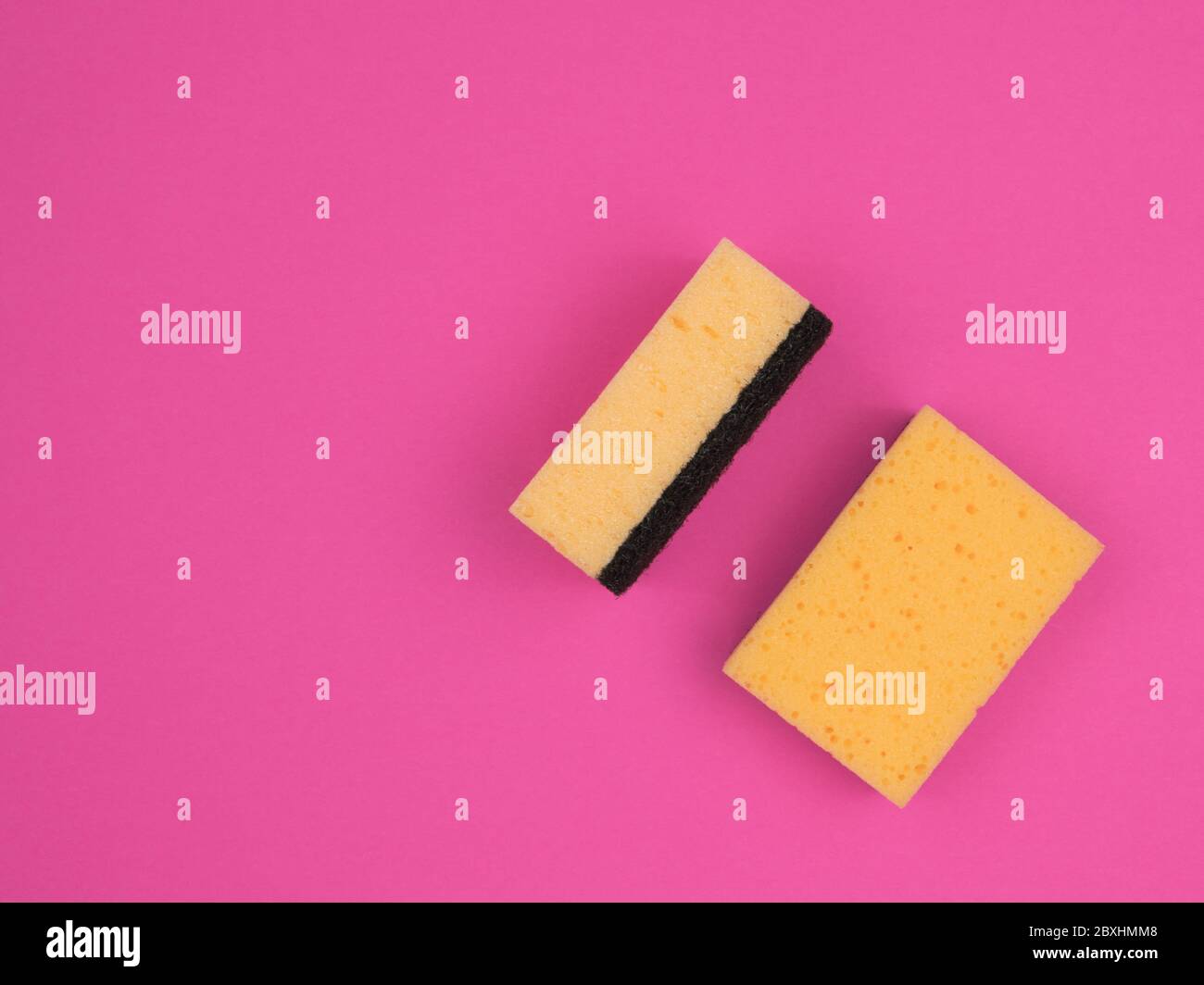 Accessories for washing dishes on a pink background Stock Photo - Alamy