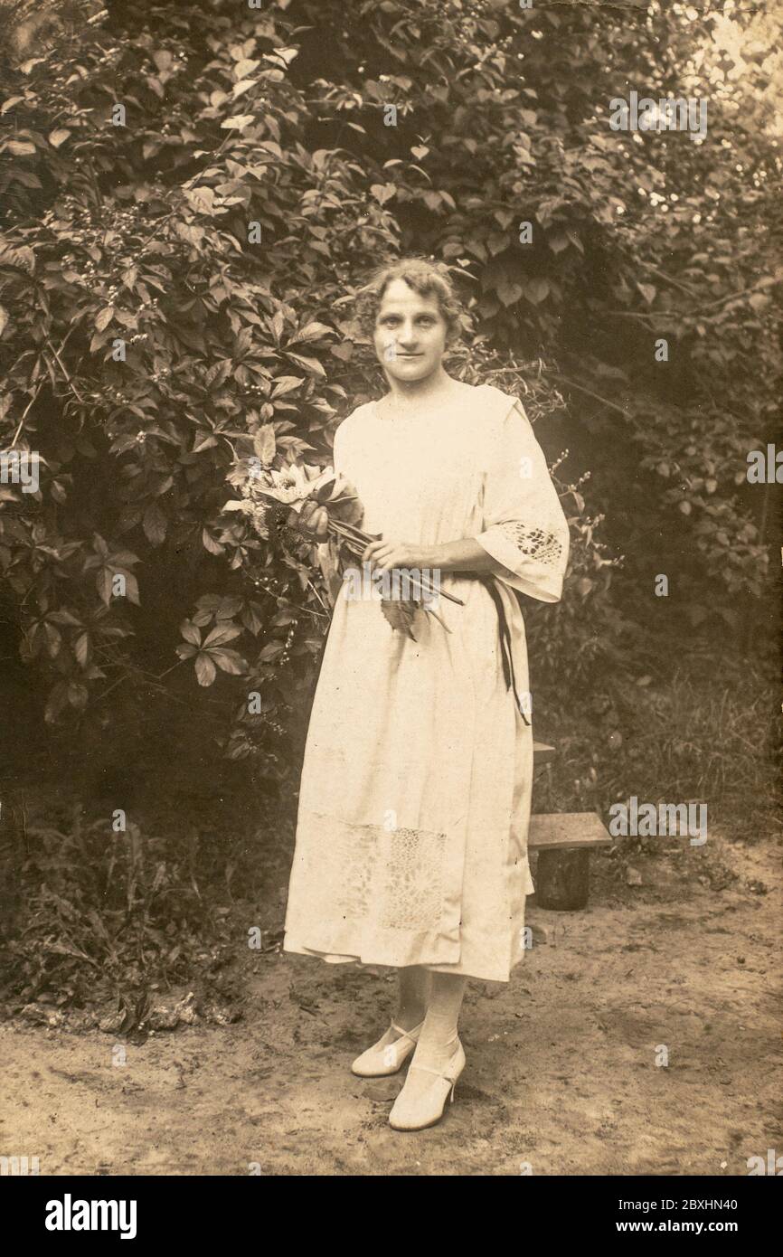 Latvia - CIRCA 1920s: Full body shot. Young women in garden. Vintage ...