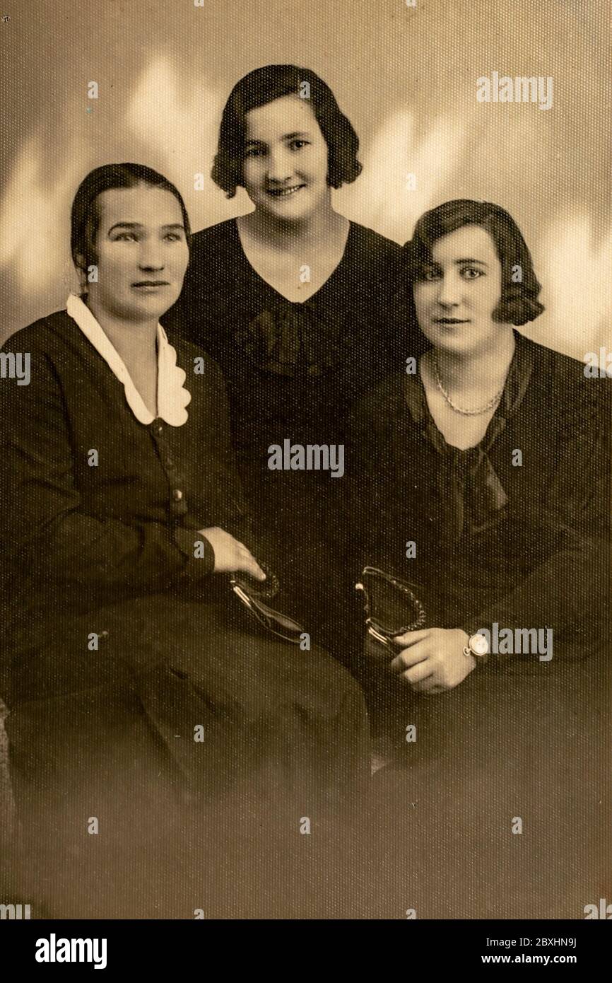 Germany - CIRCA 1930s: Portrait of three women sitting at bench in ...