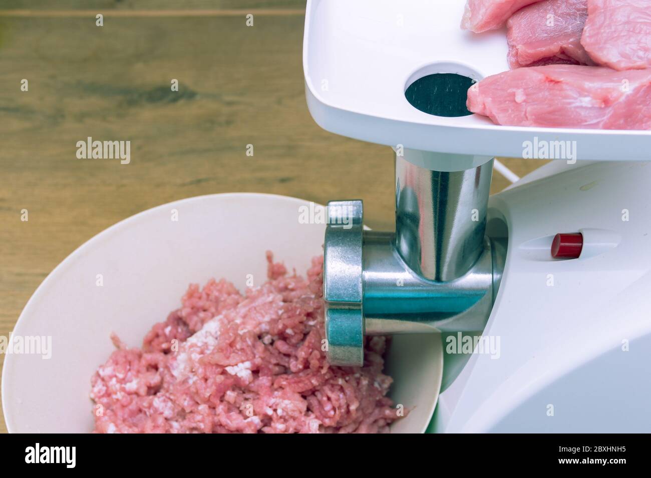 Cooking minced pork meat with a meat grinder. Home-made meat semi ...