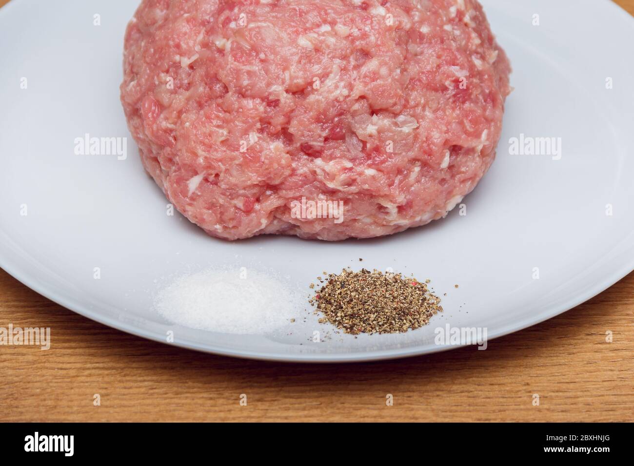 Minced pork on a plate with spec. Homemade meat semi-finished products ...