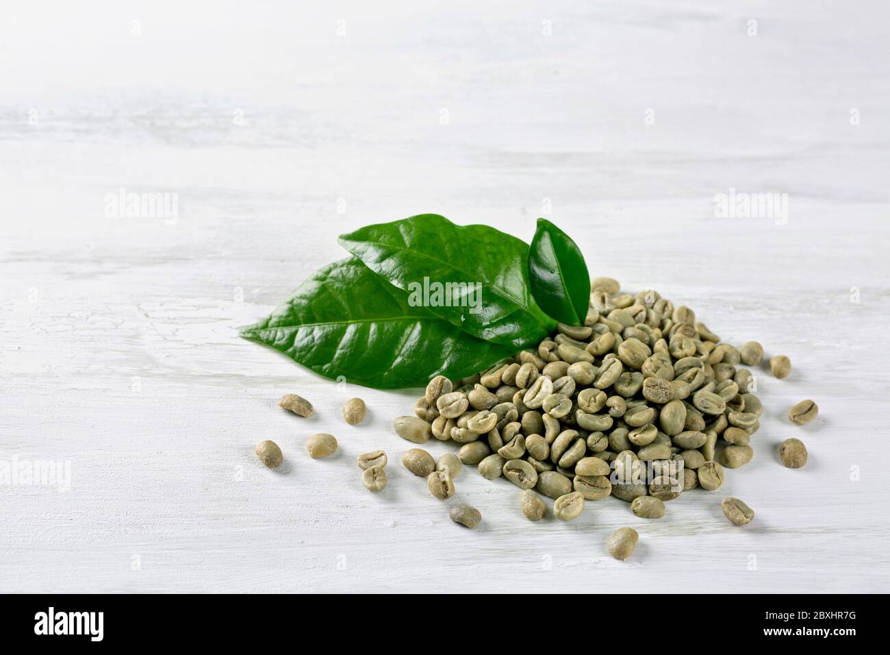 Green coffee beans on a white background Stock Photo - Alamy