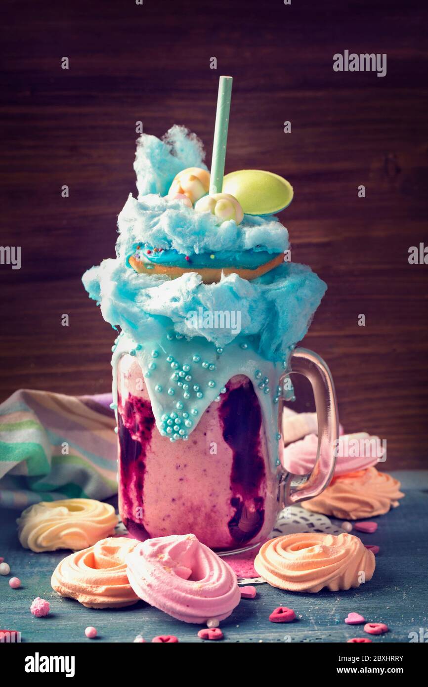 Blueberry freakshake with donuts and candy floss Stock Photo - Alamy