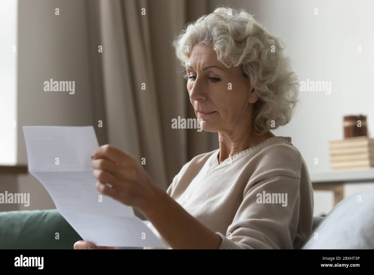 Woman reading letter pensive hi-res stock photography and images - Alamy