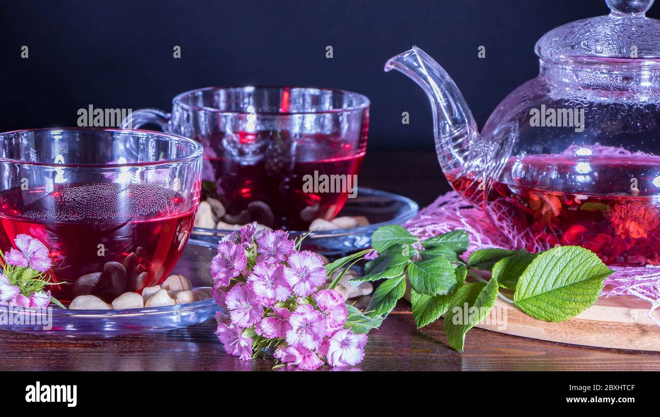 Red hot hibiscus tea in glass mug. Tea time: cup of tea, carcade ...