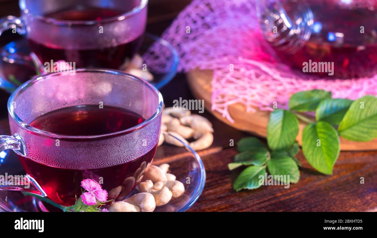 English tea. Red hot hibiscus tea in glass mug. Tea time: cup of tea ...