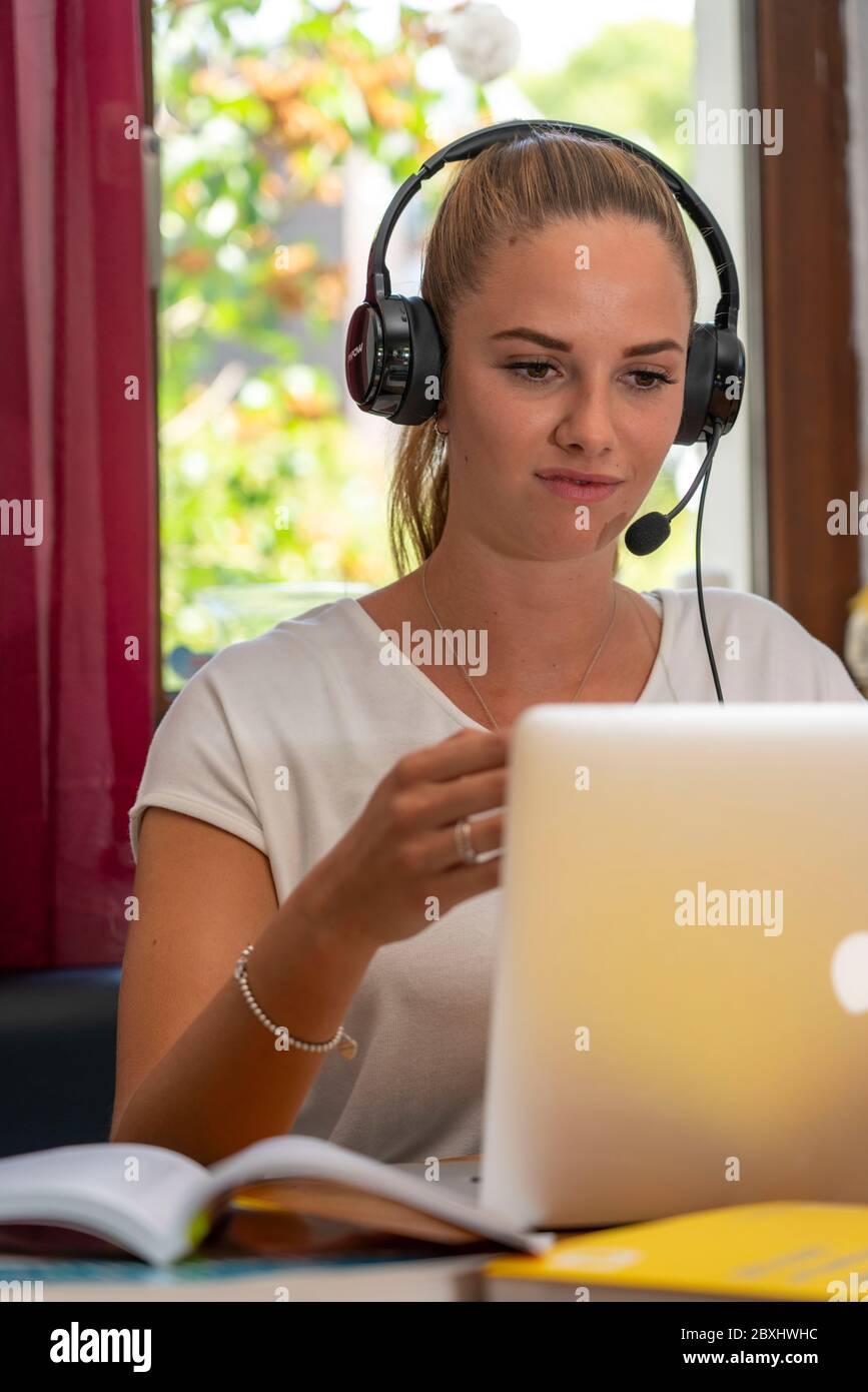 Young student learns at home, online, in conversation with other ...
