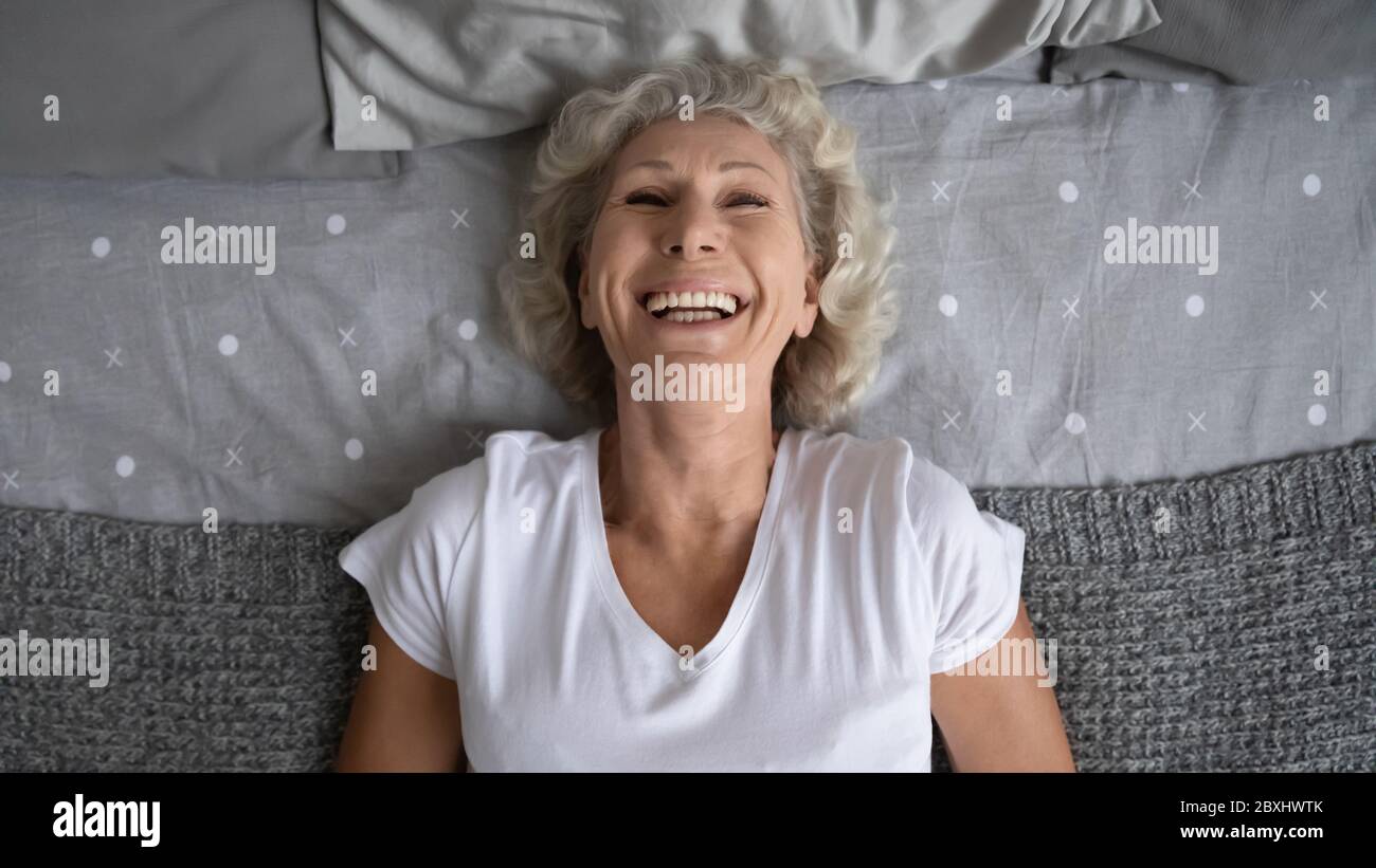 Woman mature relax bed happy hi-res stock photography and images - Alamy