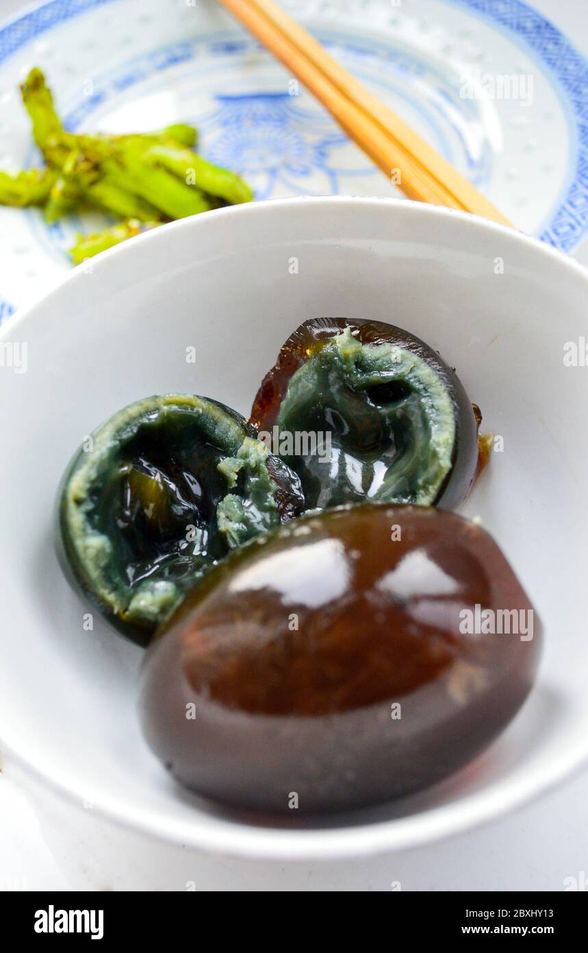 Chinese Century Eggs (Pi Dan) in White Bowl. One Egg Cut in Half Shows ...