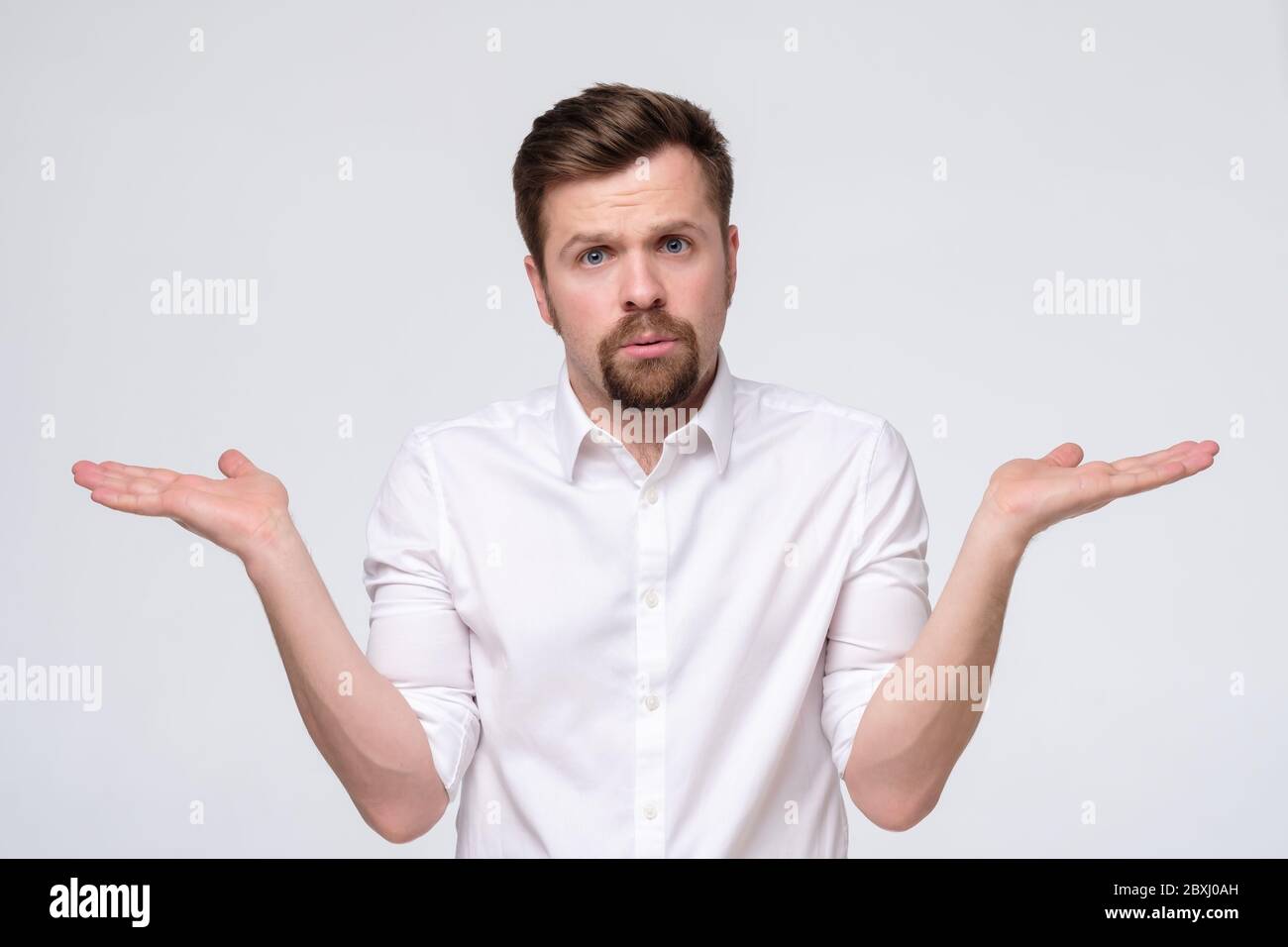 Doubtful man hesitates what answer to give. Uncertaing male coworker is ...