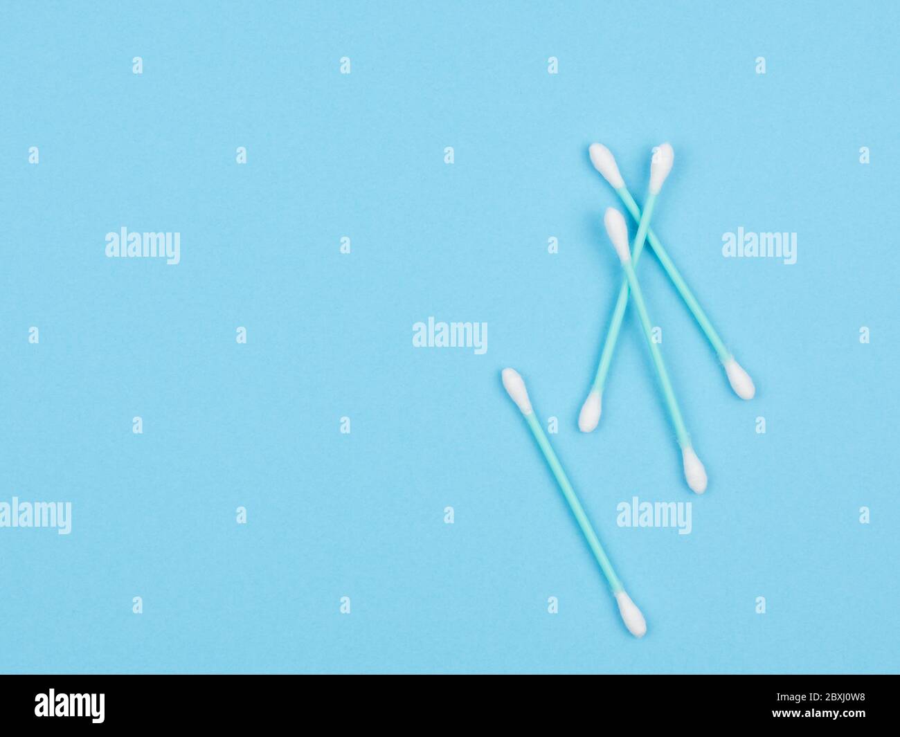 Ear sticks on a blue background Stock Photo - Alamy