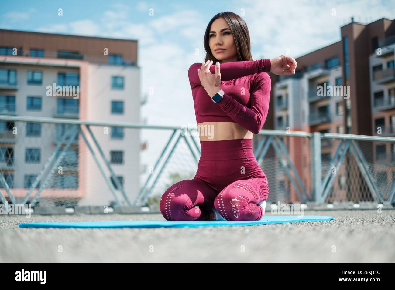 Woman doing workout alone on a roof Stock Photo - Alamy