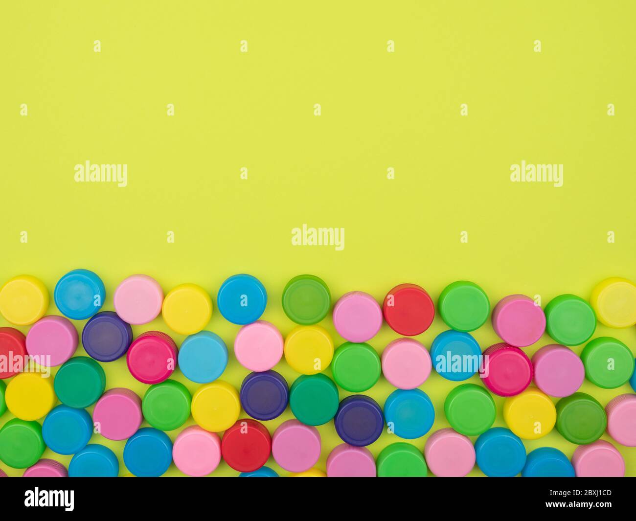 Colored plastic cover on the green background Stock Photo - Alamy