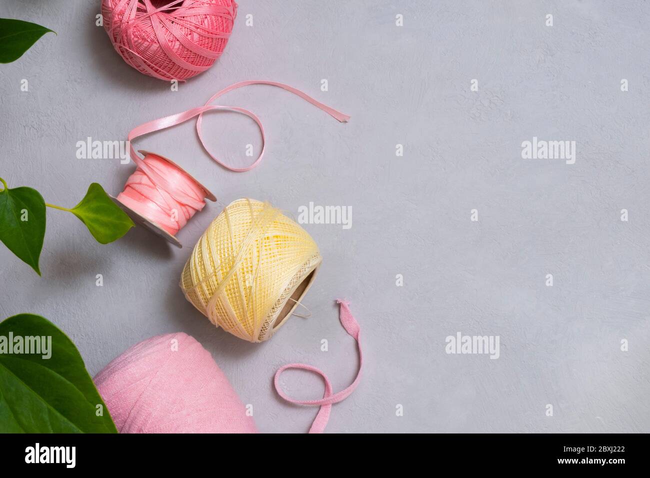 Different yarns on neutral grey background. Image with copy space, top ...