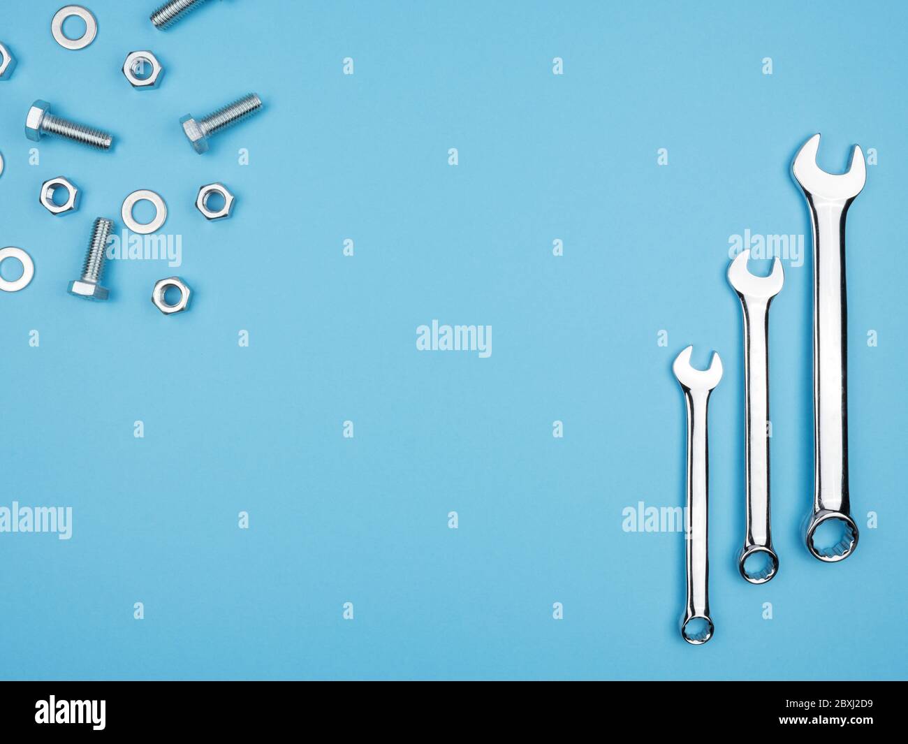 Repair keys, bolts and nuts on a blue background Stock Photo - Alamy