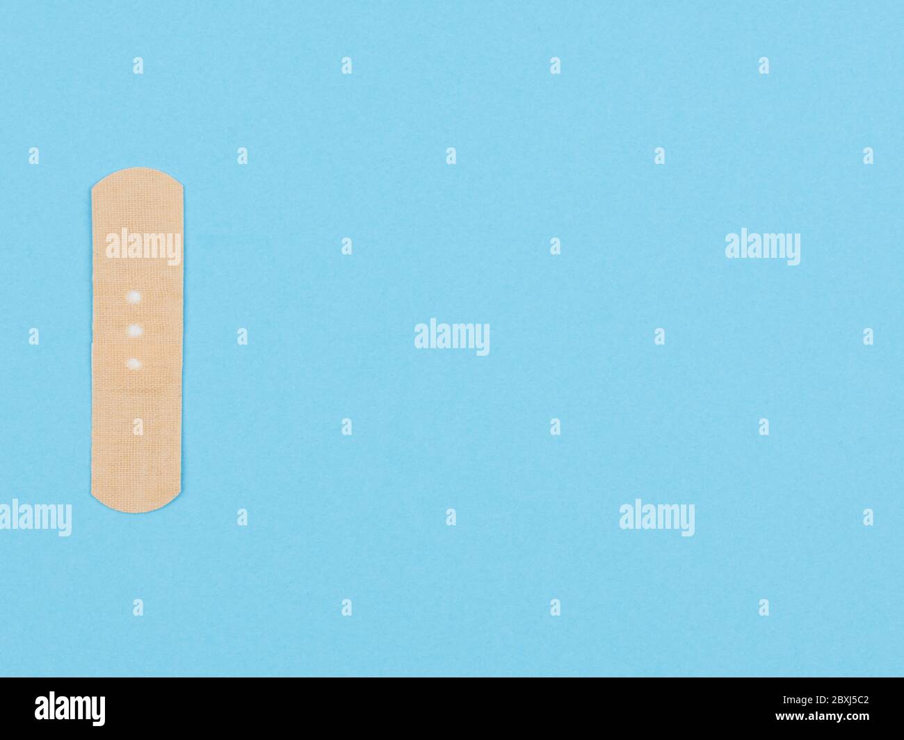 Band-aid on a blue background Stock Photo - Alamy