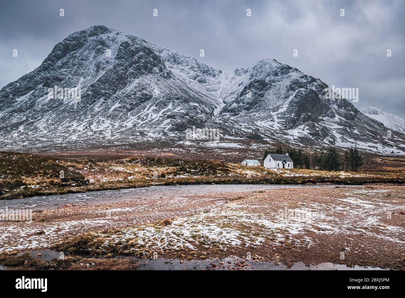 Picturesque winter landscape of Glen Coe with the iconic white cottage ...