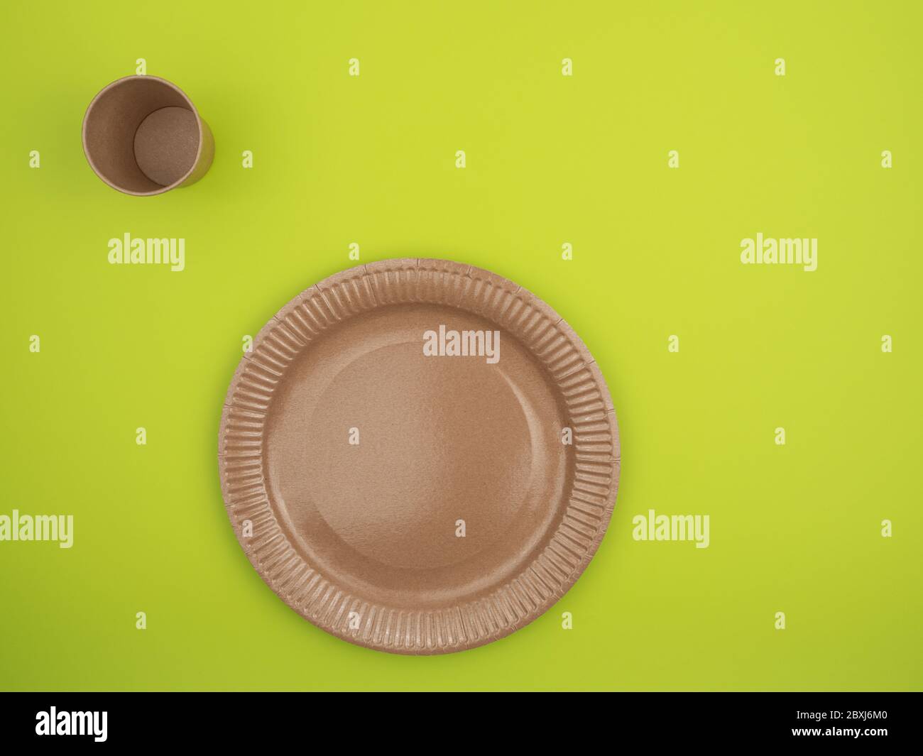 A paper plate and a glass on a green background Stock Photo - Alamy