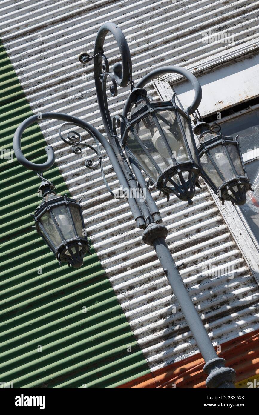 A street Lamp in front of a colourful corrugated iron building in the ...