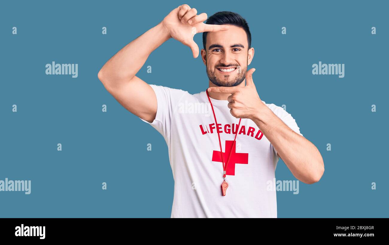 Young handsome man wearing lifeguard uniform smiling making frame with ...