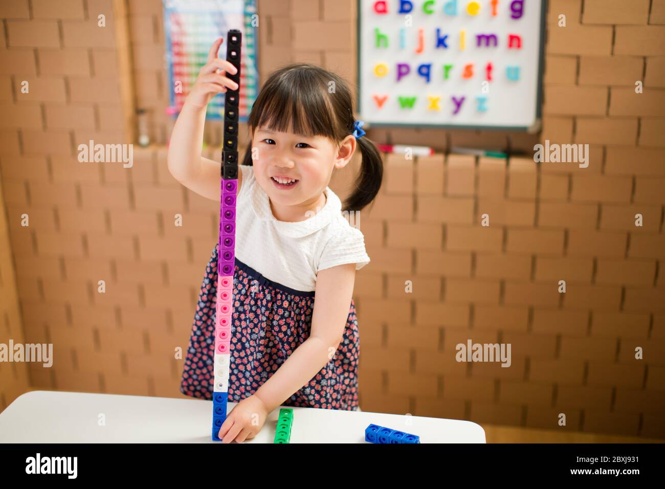 toddler girl play number blocks for homeschooling Stock Photo - Alamy