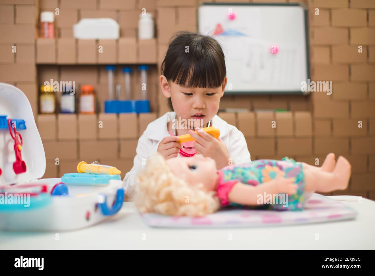 toddler girl pretend play doctor role at home Stock Photo - Alamy