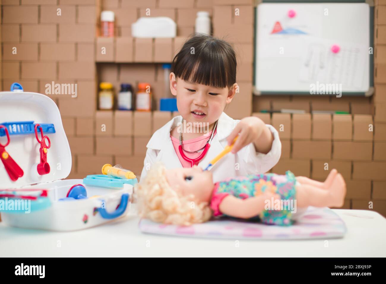 toddler girl pretend play doctor role at home Stock Photo - Alamy