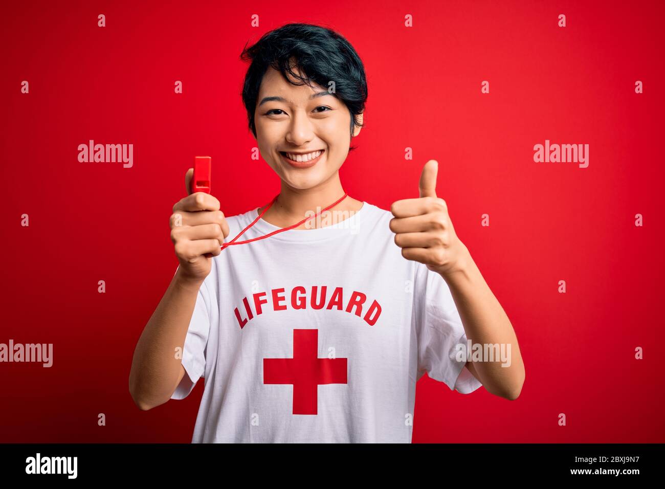Young beautiful asian lifeguard girl wearing t-shirt with red cross ...