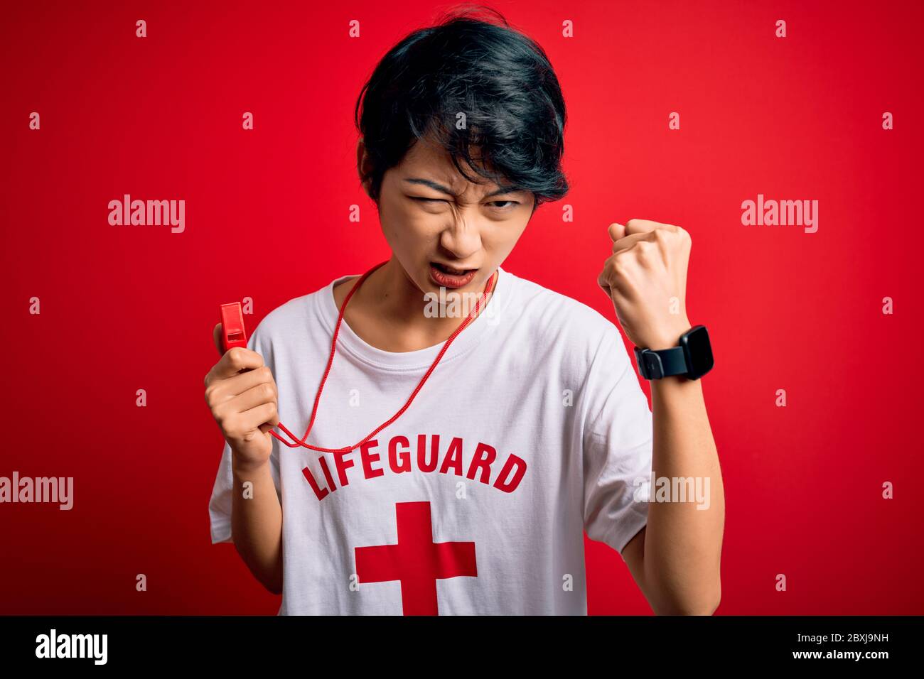 Young beautiful asian lifeguard girl wearing t-shirt with red cross ...