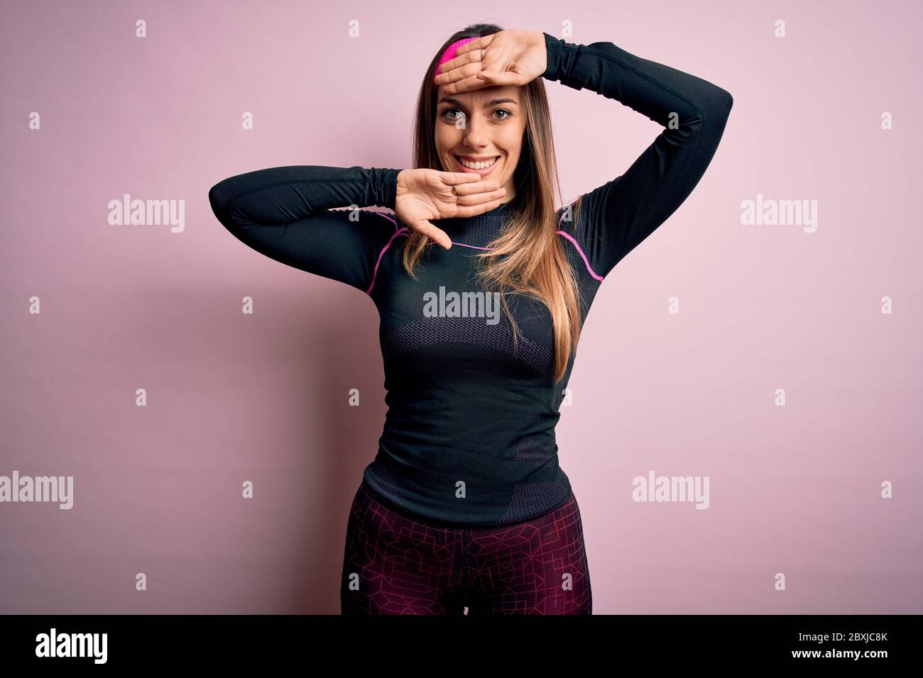 Young blonde fitness woman wearing sport workout clothes over isolated ...