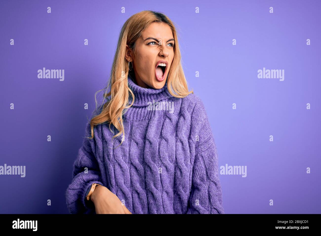 Young beautiful blonde woman wearing casual turtleneck sweater over ...