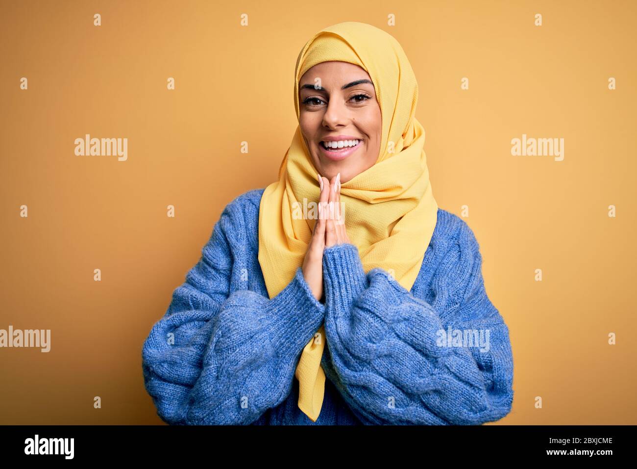 Young beautiful brunette muslim woman wearing arab hijab over isolated ...