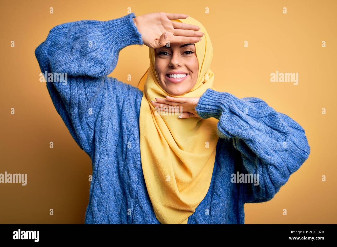 Young beautiful brunette muslim woman wearing arab hijab over isolated ...