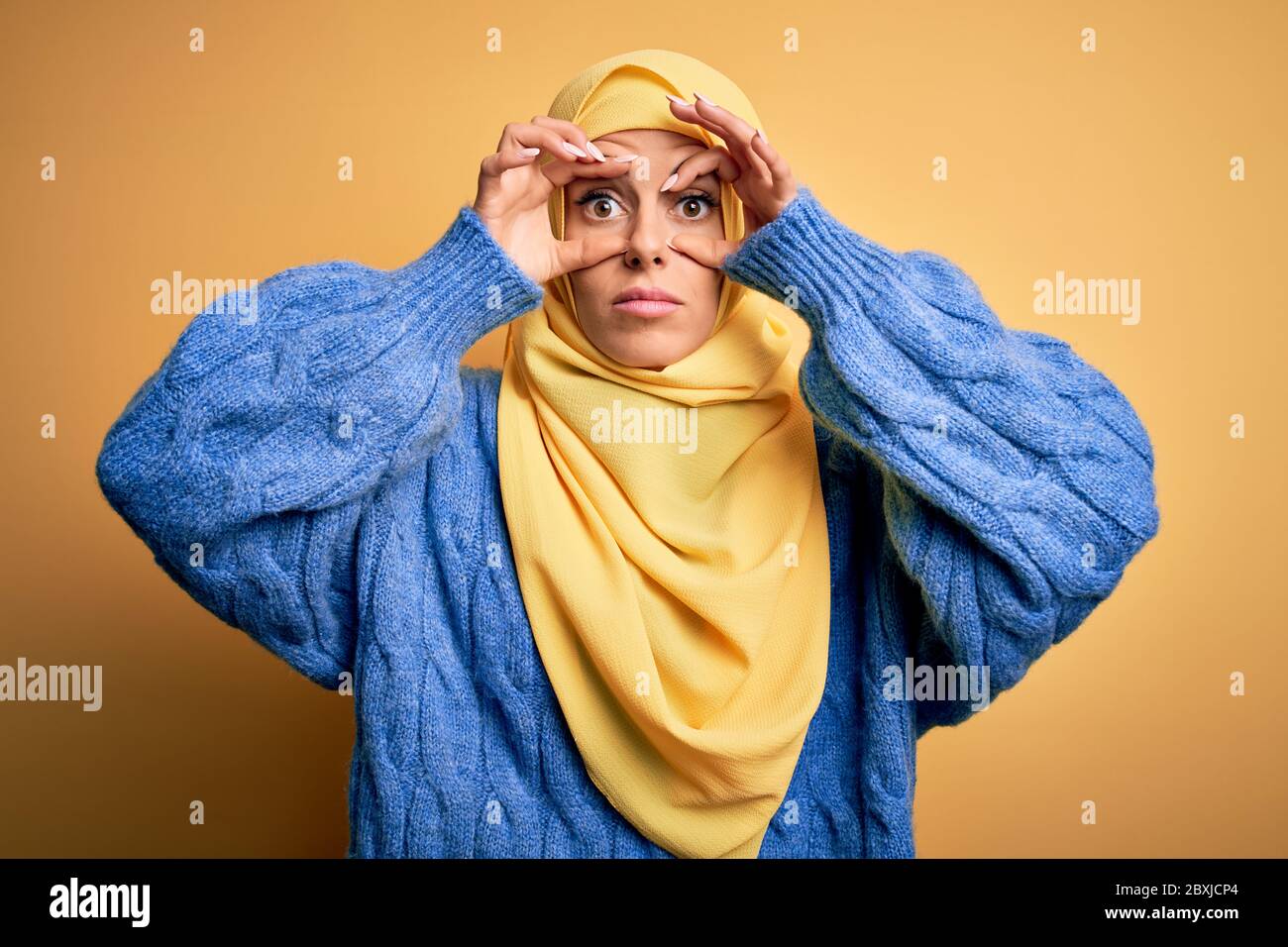 Young beautiful brunette muslim woman wearing arab hijab over isolated ...