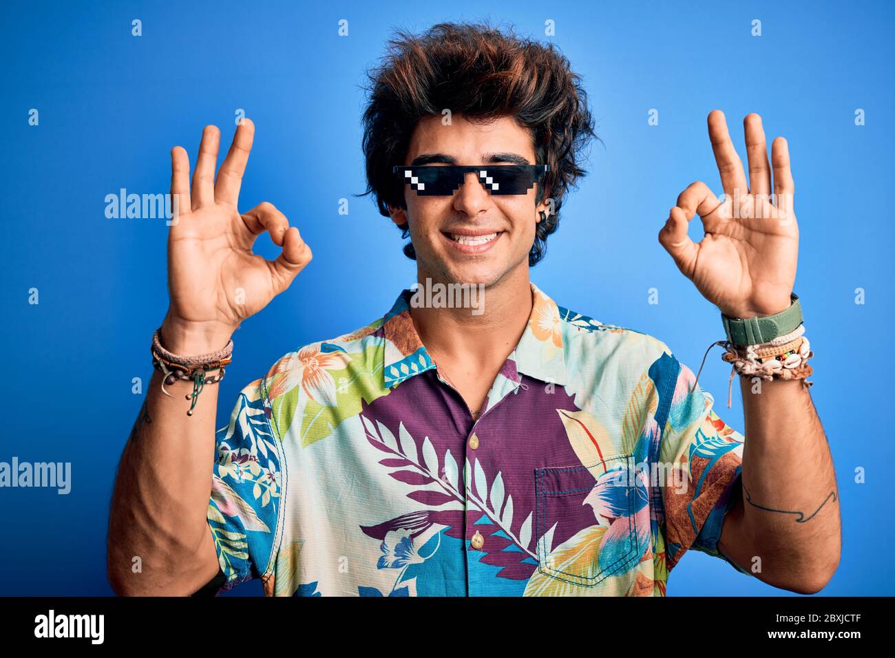 Young handsome man wearing thug life glasses standing over isolated ...