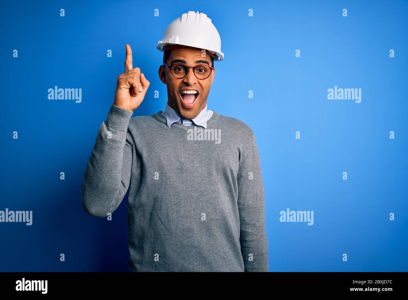 Young handsome african american engineer man with dreadlocks wearing ...