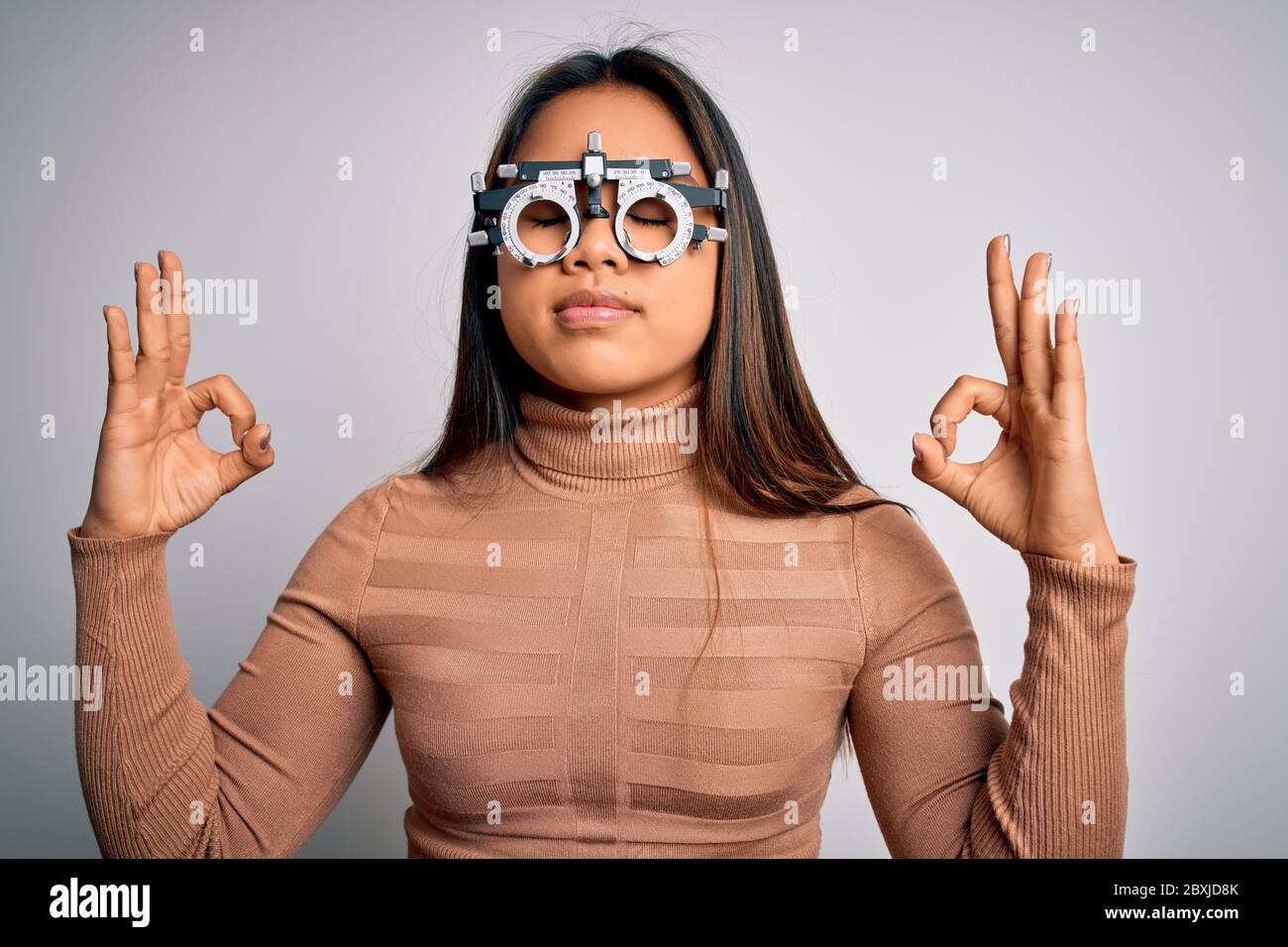 Young asian optical girl controlling eyesight using optometry glasses ...
