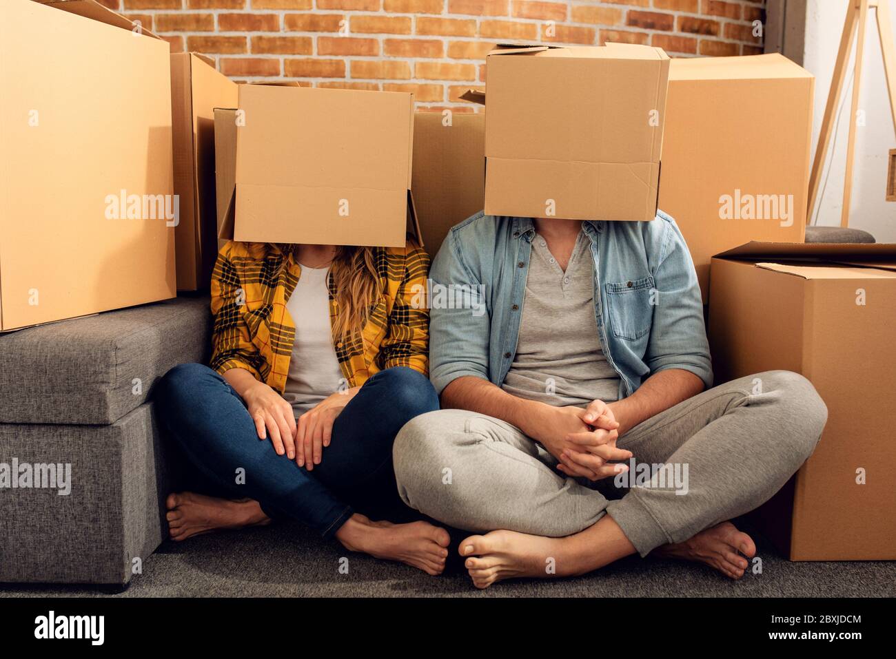 Confused couple of having to move and arrange all the packages. Concept ...