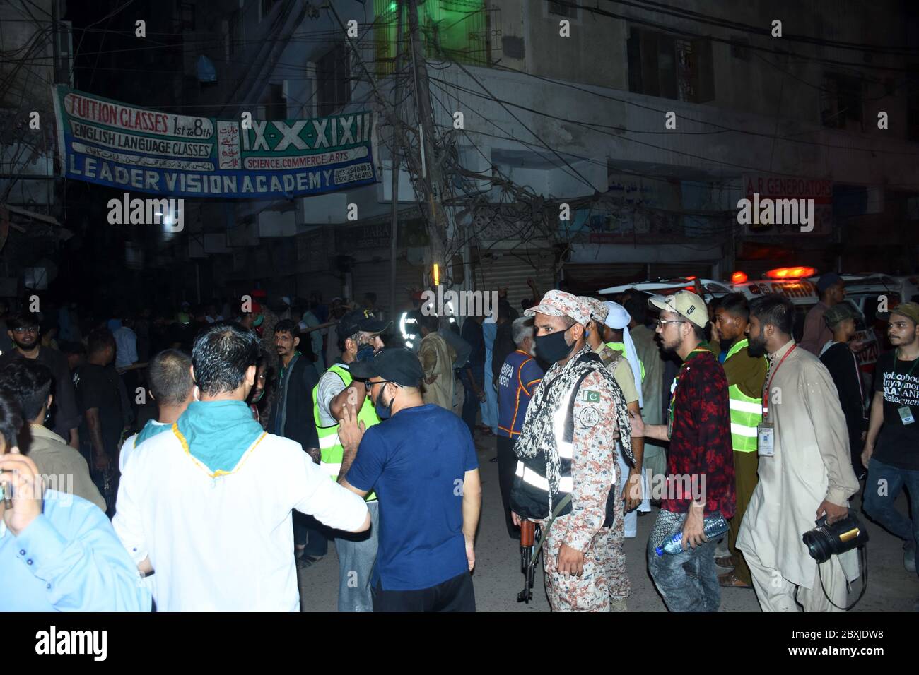 Karachi, Pakistan. 7th June, 2020. Local residents gather near the site ...