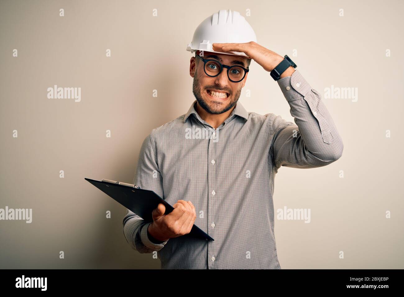 Young architect inspector man wearing builder safety helmet and using ...