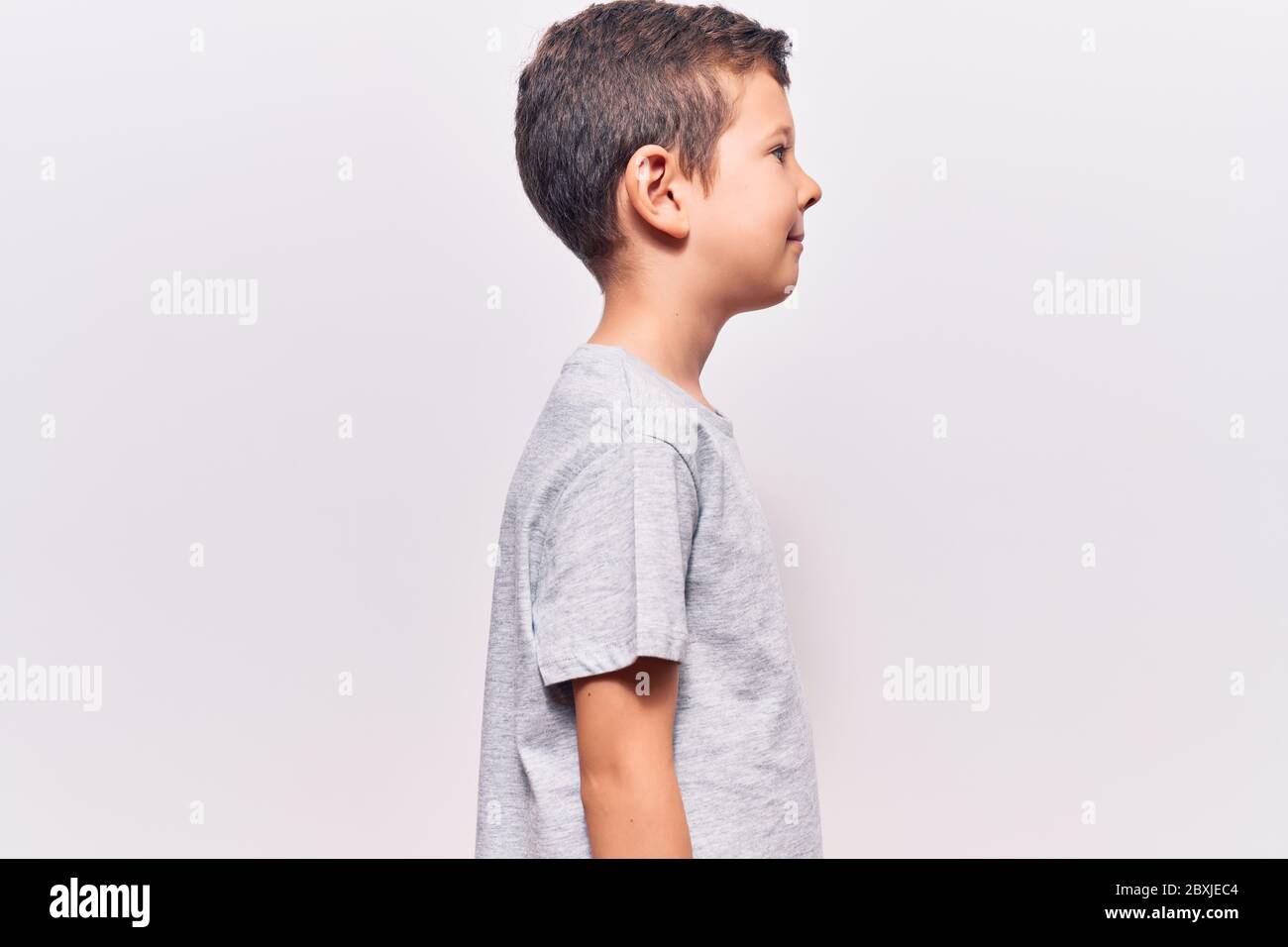 Cute blond kid wearing casual clothes looking to side, relax profile ...