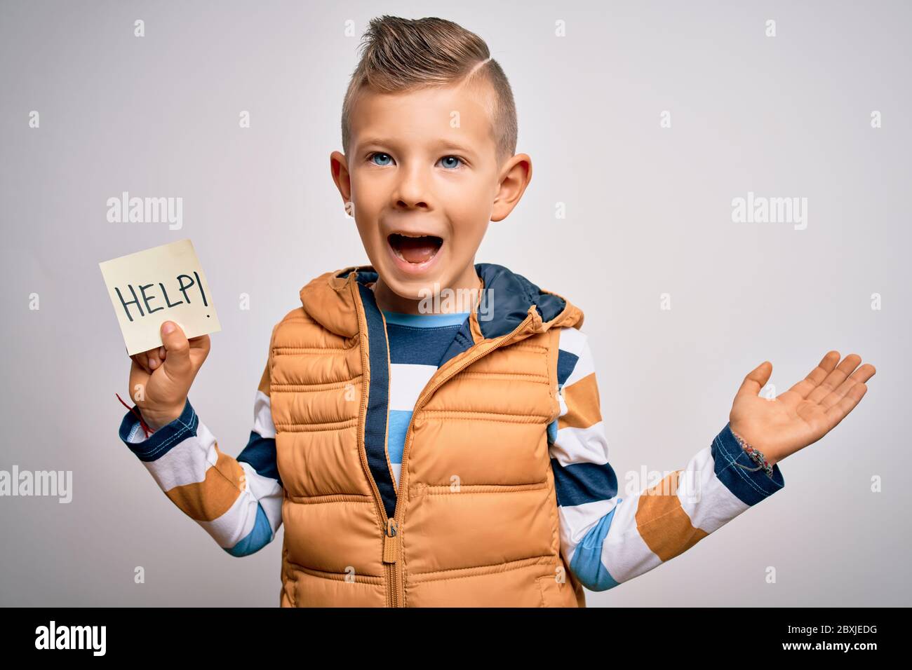 Young little caucasian kid asking for help on a paper note as violence ...