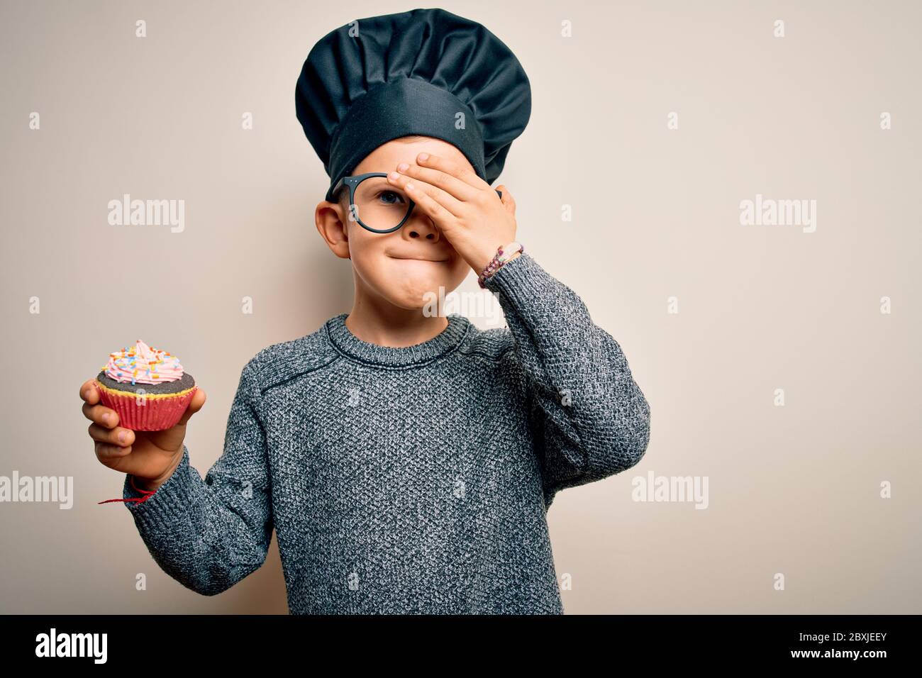 Young little caucasian cook kid wearing chef uniform and hat cooking ...