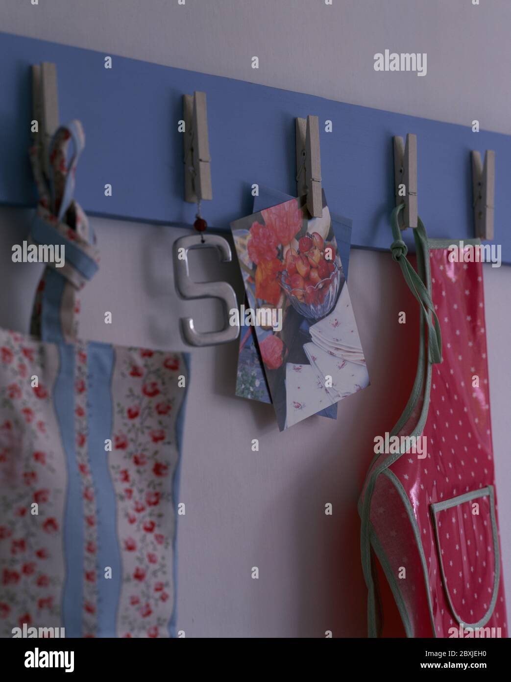Clothes pegs stuck on painted board make clever storage idea Stock ...