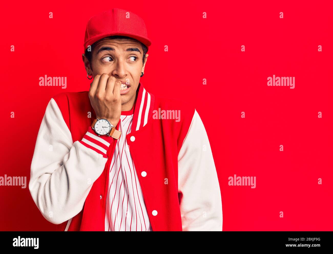 Young african amercian man wearing baseball uniform looking stressed ...